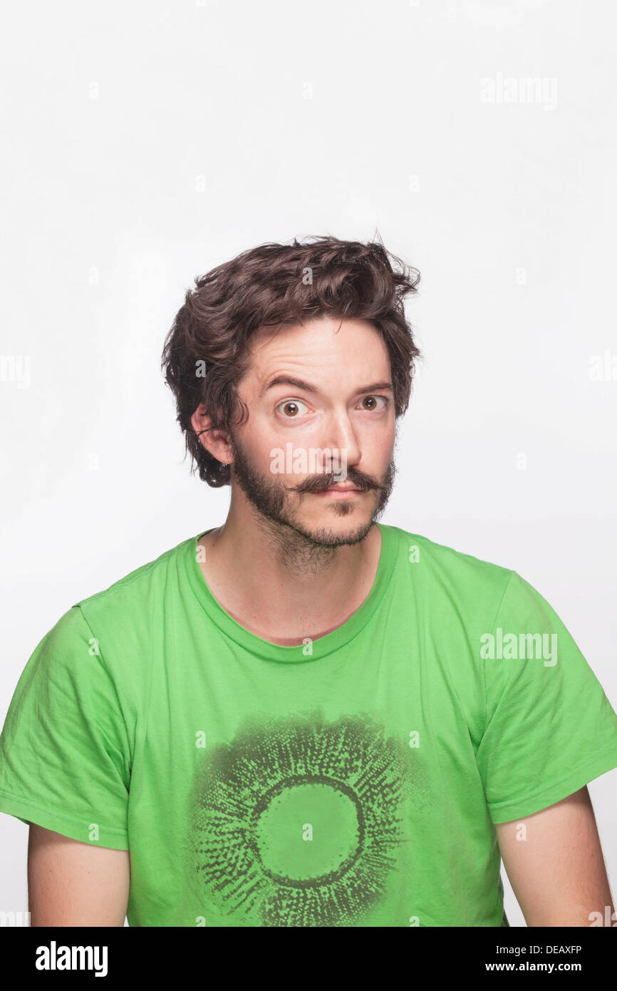 Young man with eyebrow raised looking at camera, studio shot Stock ...