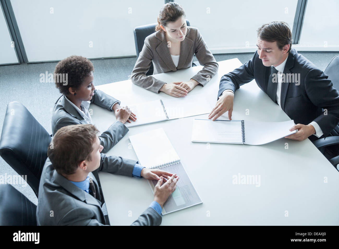Four men sitting around table hi-res stock photography and images - Alamy