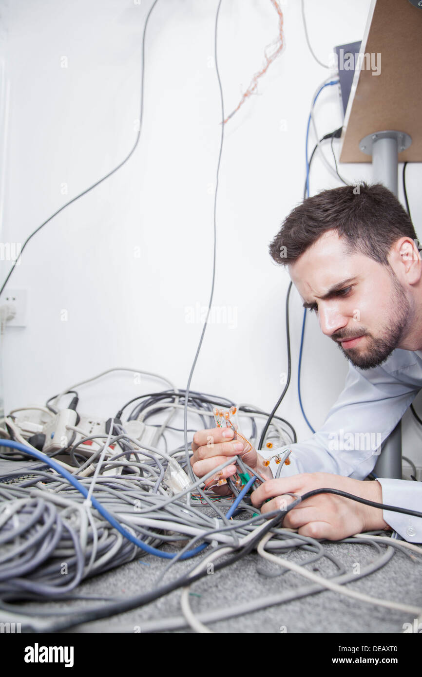 Man plugging in cables hi-res stock photography and images - Alamy