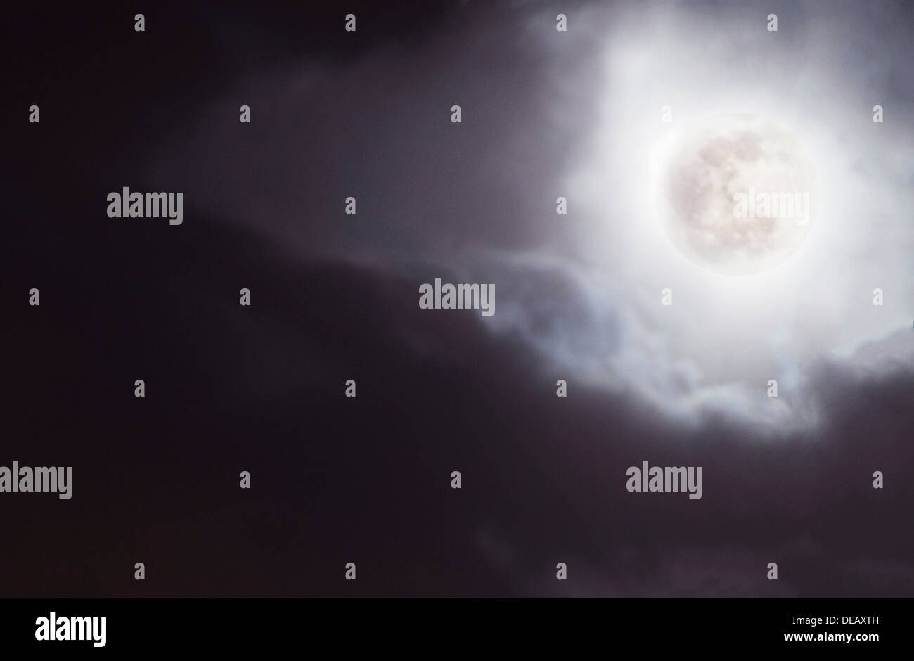 Full moon in night sky with clouds Stock Photo - Alamy