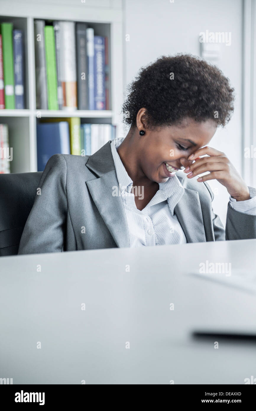 Portrait laughing businesswoman table hi-res stock photography and ...