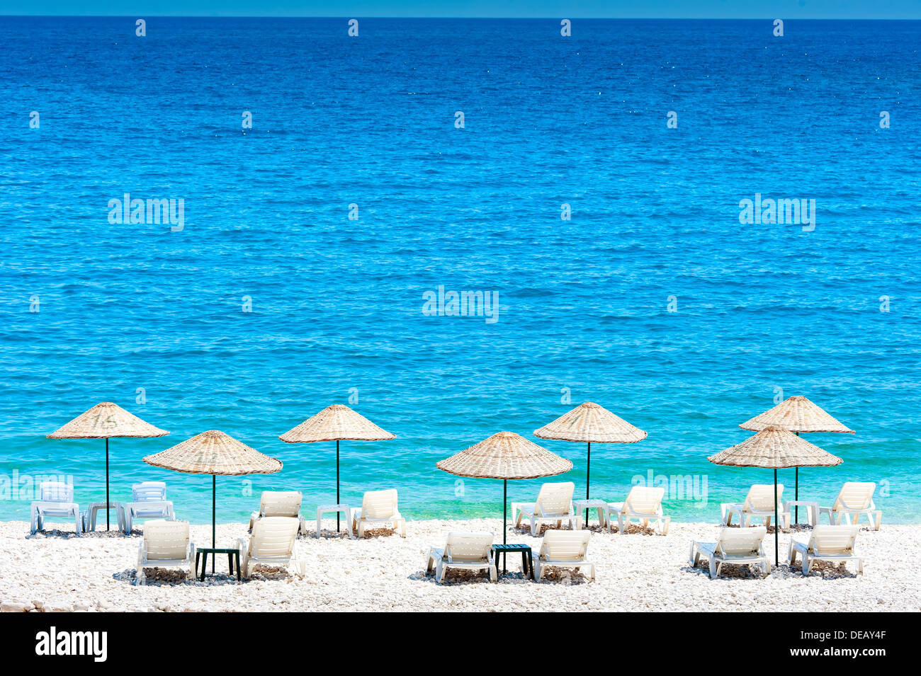 wicker beach umbrellas on the beach Stock Photo - Alamy