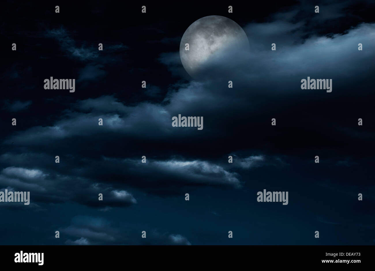 Full moon in night sky with clouds Stock Photo - Alamy