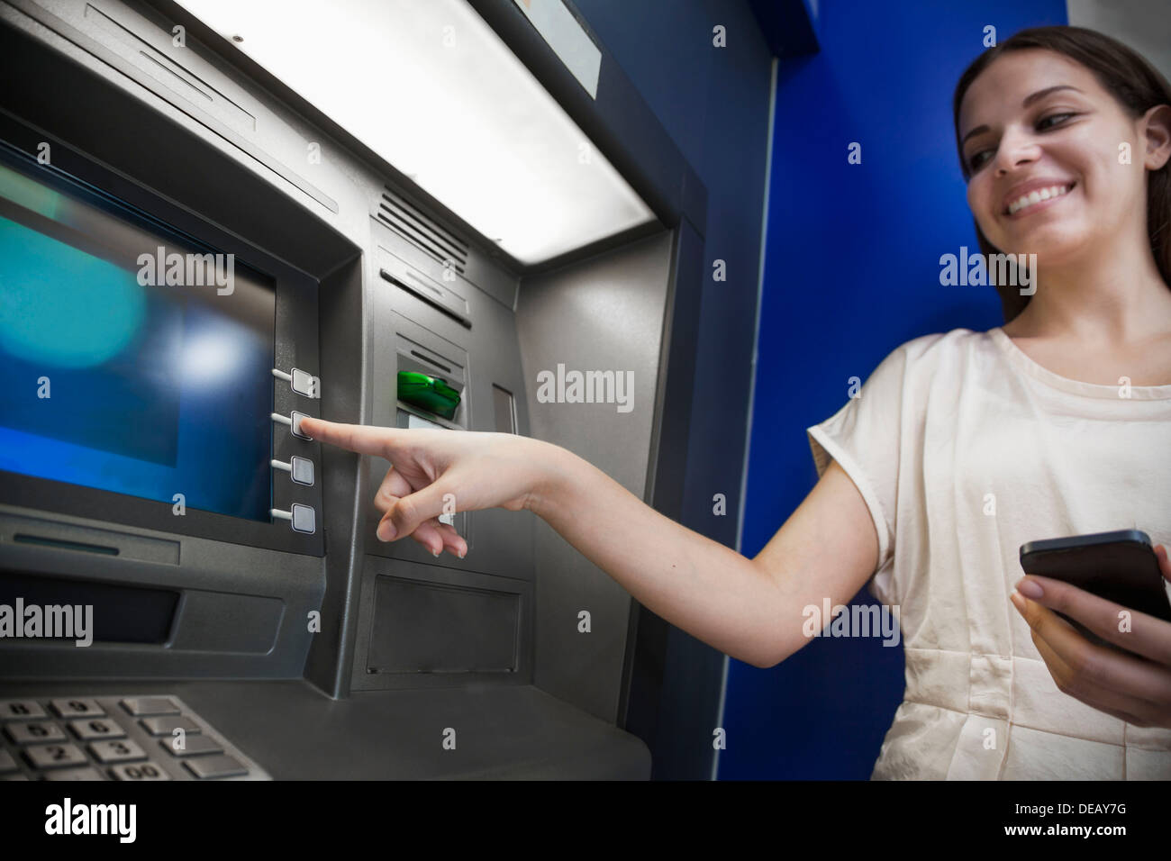 Woman withdrawing money from atm hi-res stock photography and images ...