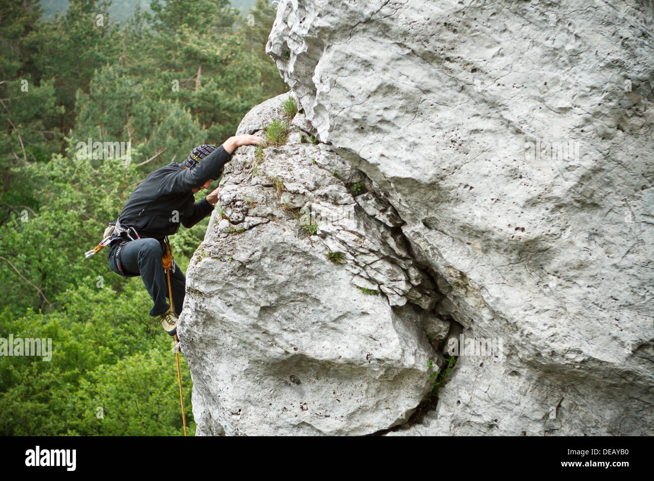 Rock climber leading a difficult climbing route on limestone rock Stock ...