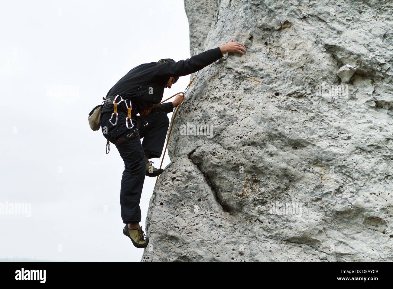 Rock climber leading a difficult climbing route on limestone rock Stock ...