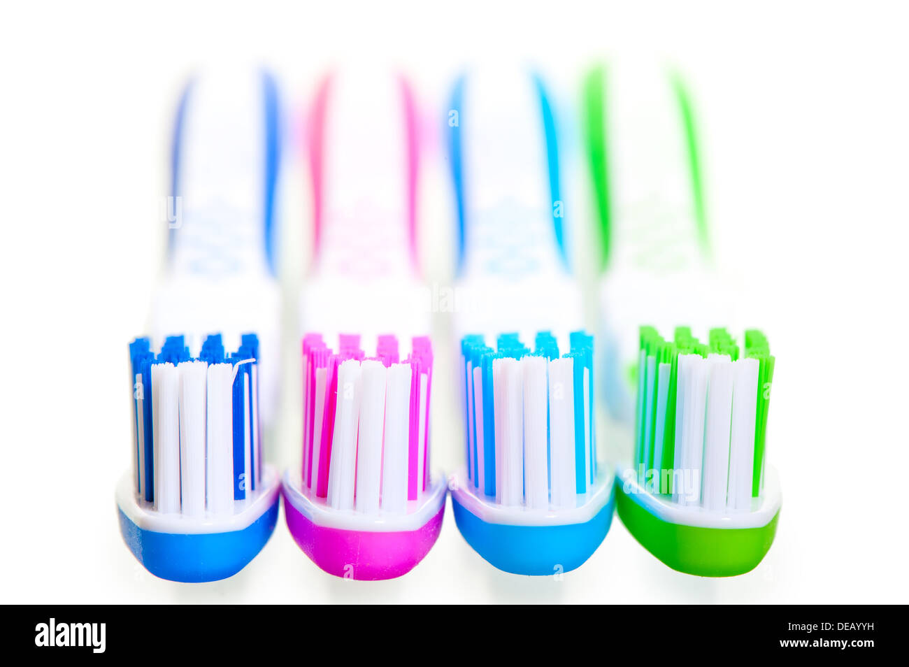 four new multi-colored toothbrushes are on a white background Stock ...
