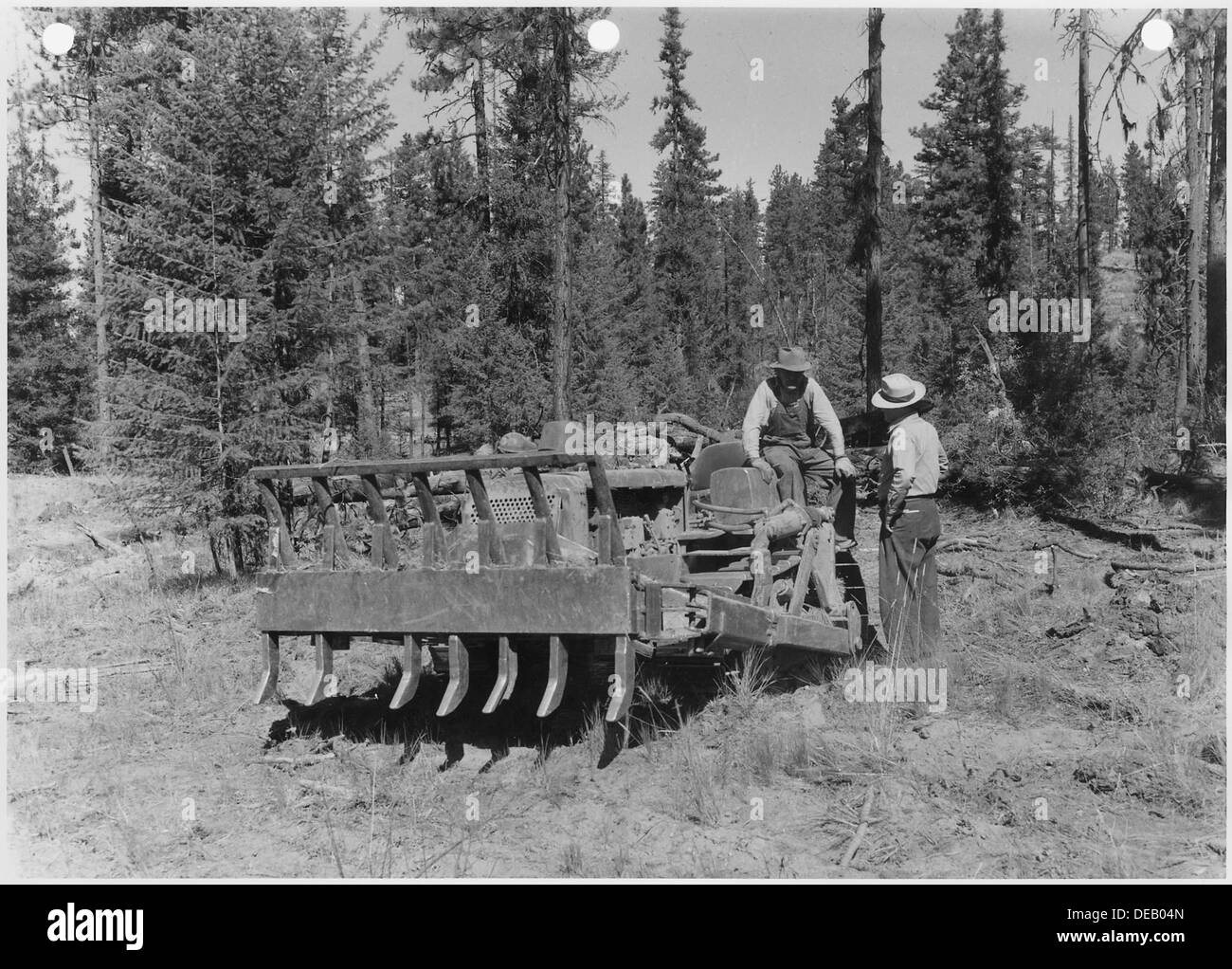 The Biles-Coleman slash piling tractor is shown with its blade raised ...
