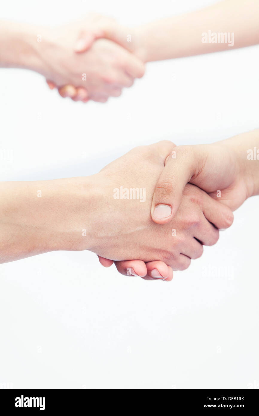 Four young people shaking hands, close-up, studio shot Stock Photo - Alamy