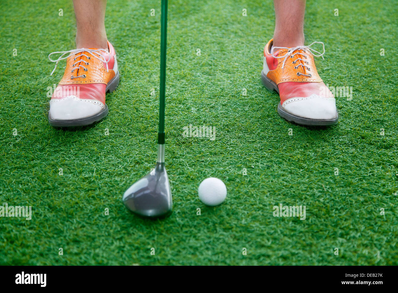 Close up on feet and golf club getting ready to hit a golf ball Stock ...