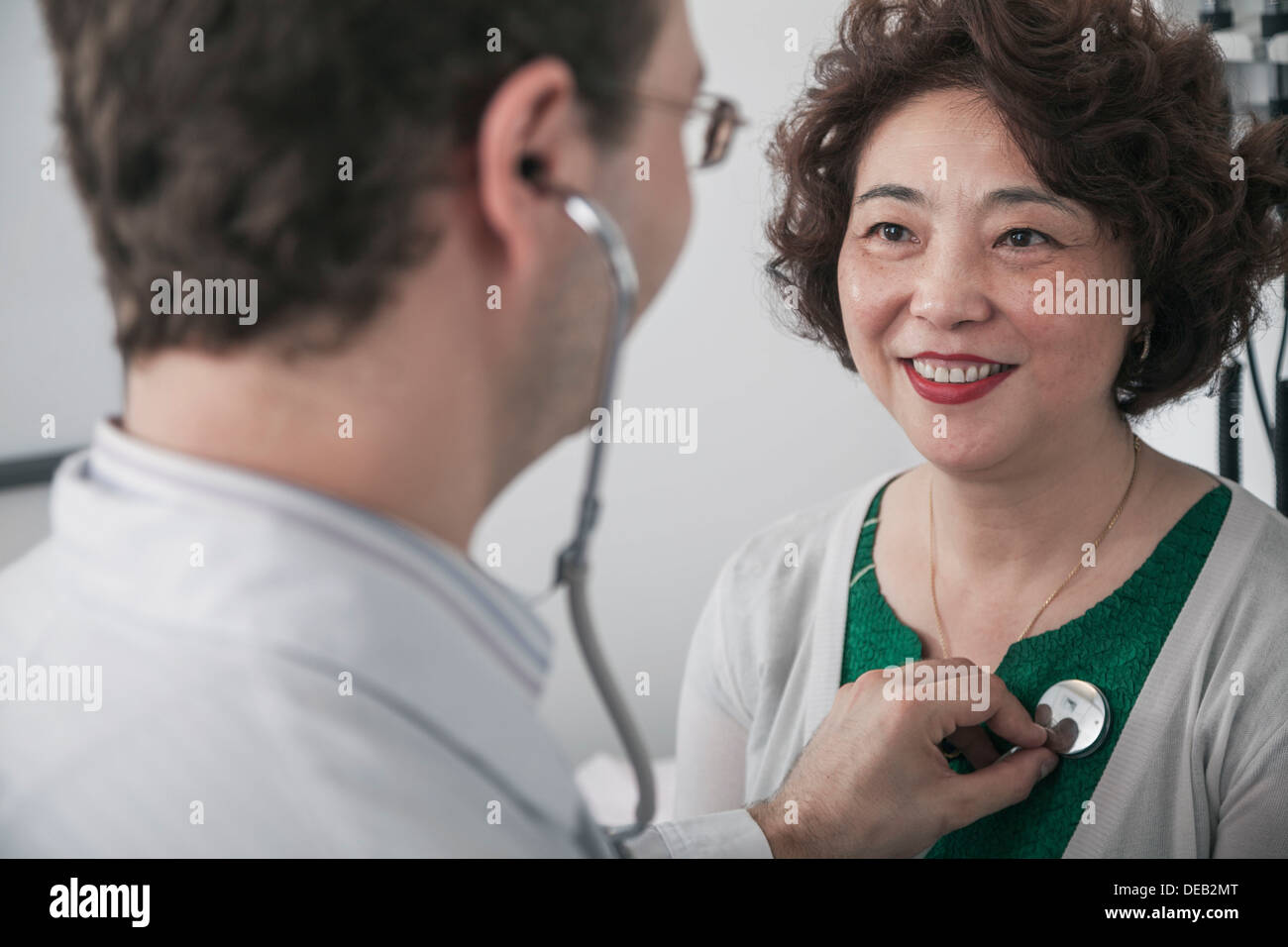 Doctor checking heartbeat of a patient with a stethoscope Stock Photo ...