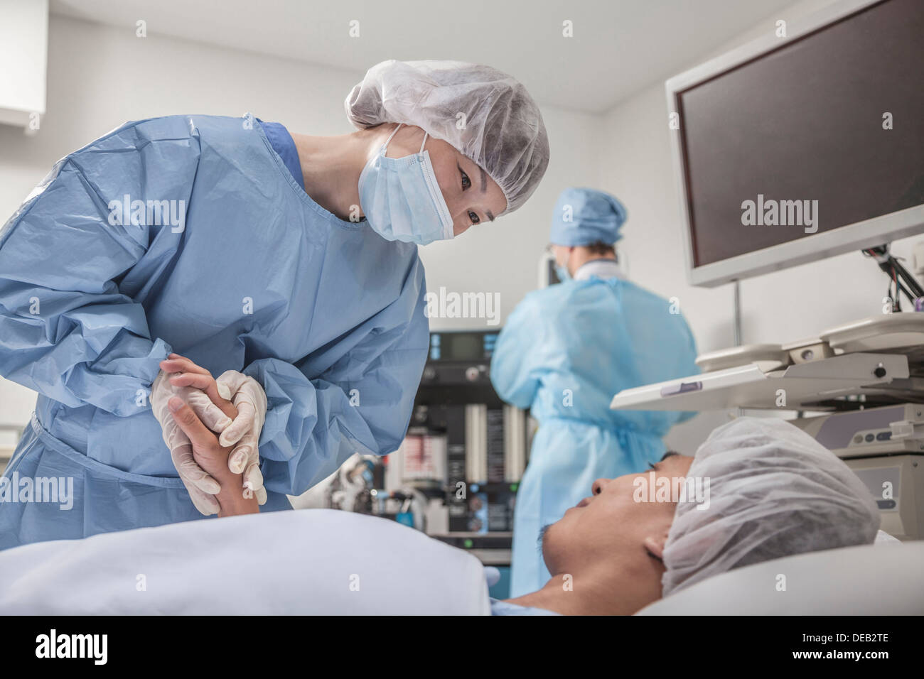 Surgeon consulting a patient, holding hands, getting ready for surgery ...