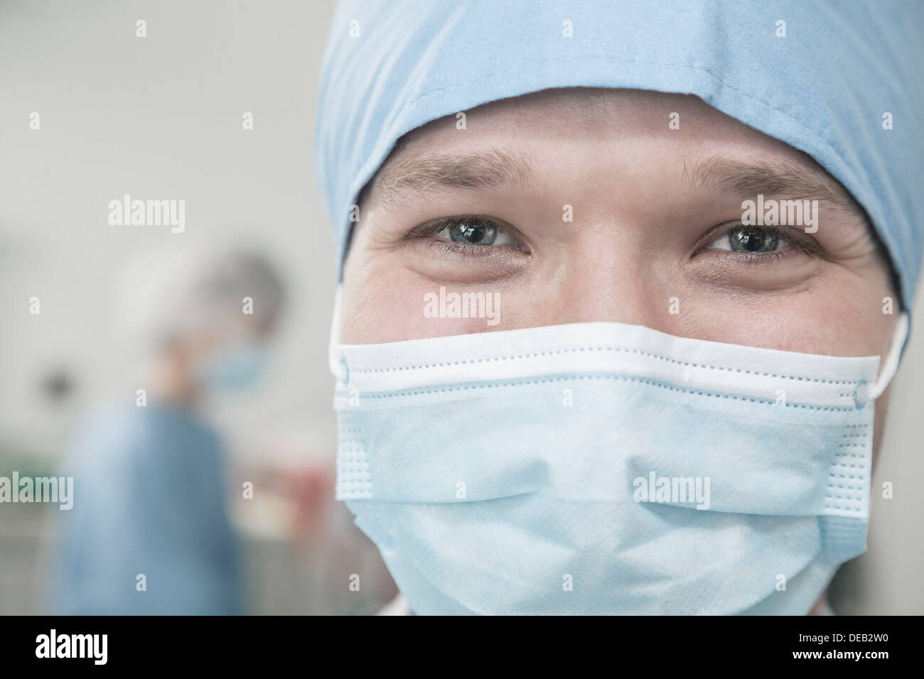 Portrait of surgeon with surgical mask and surgical cap in the ...