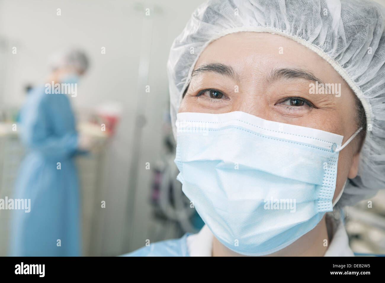 Portrait of surgeon with surgical mask and surgical cap in the ...