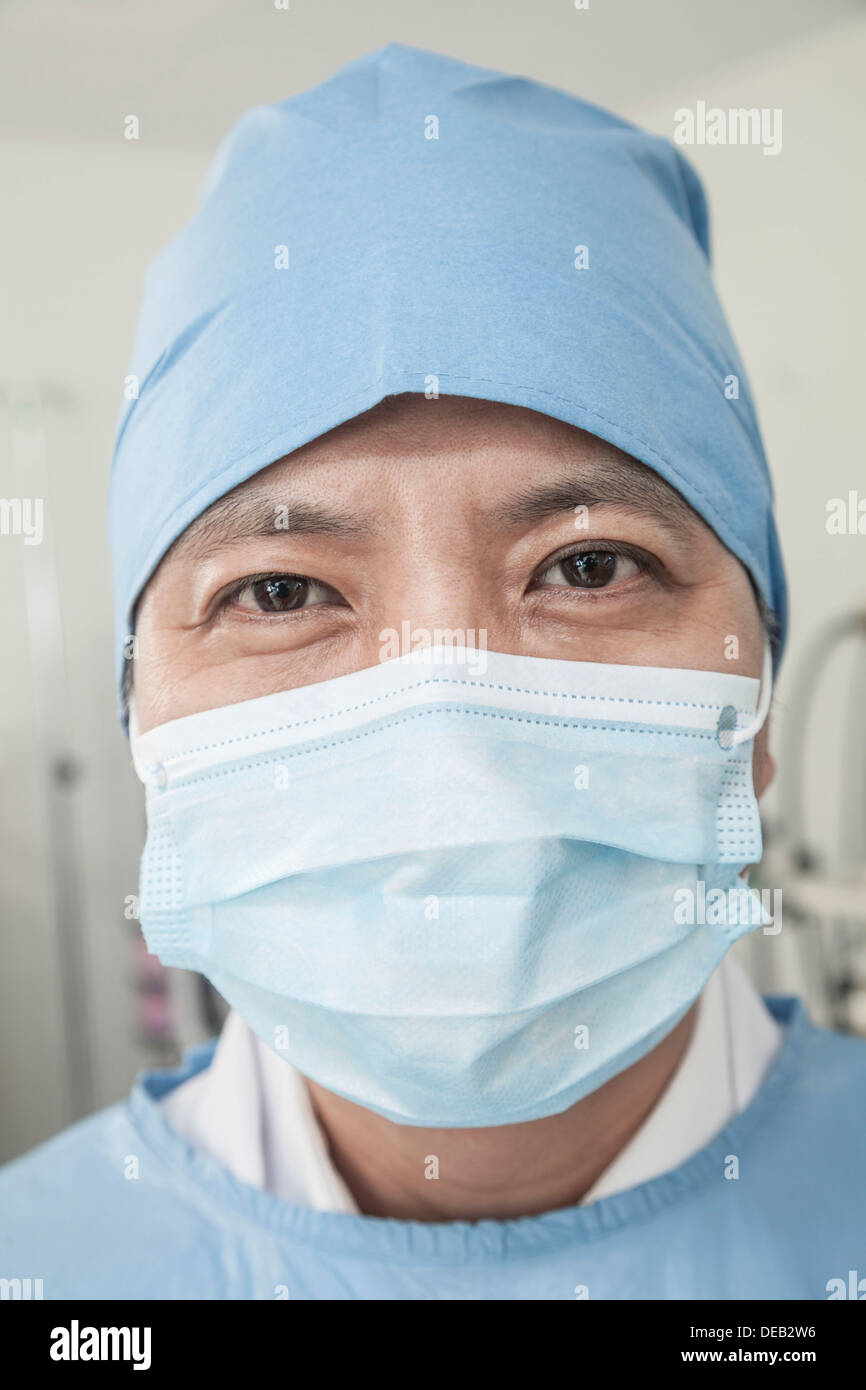 Portrait of surgeon with surgical mask and surgical cap in the ...