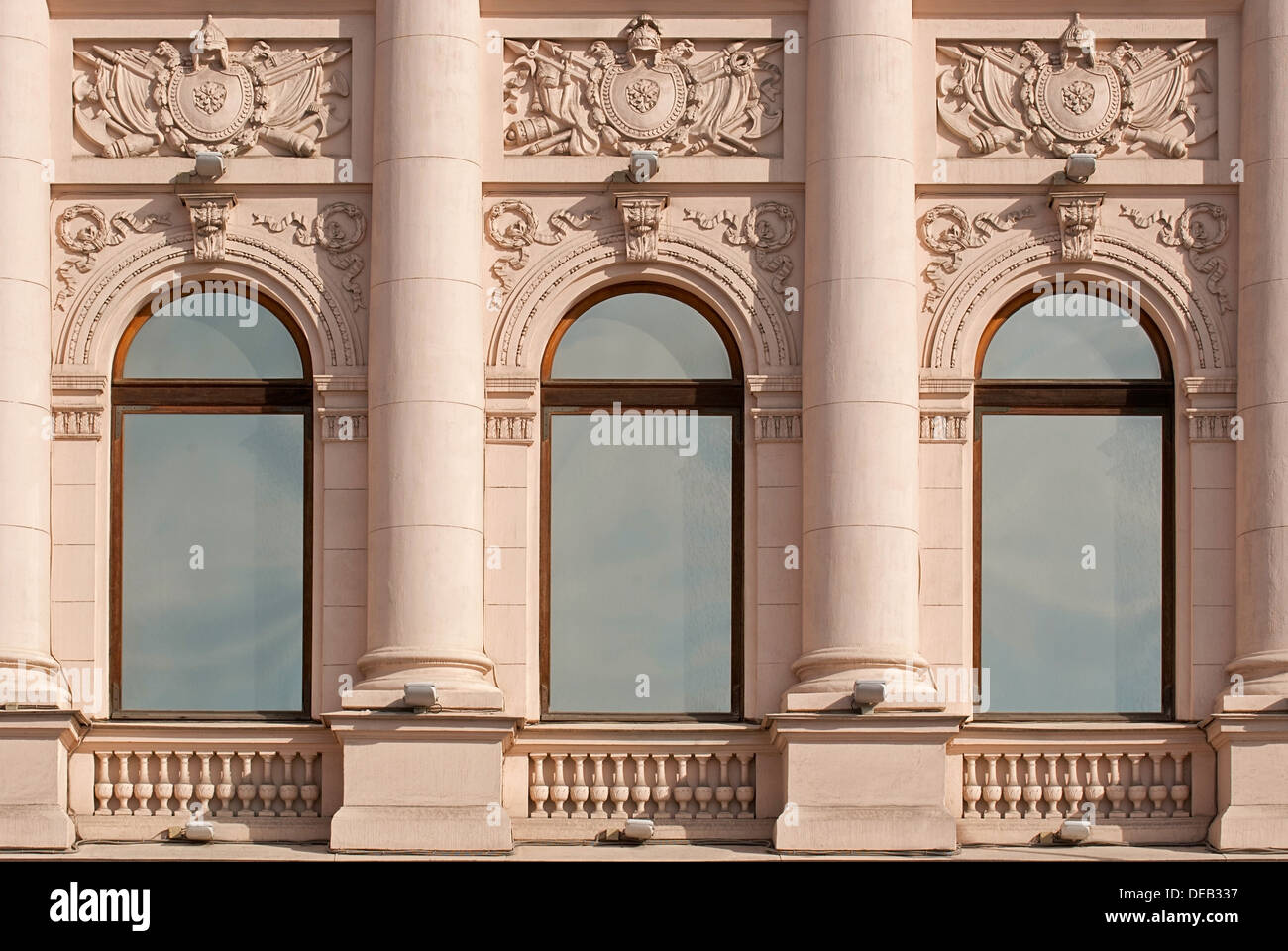 Windows with columns on a beige background wall with bas-relief. From ...