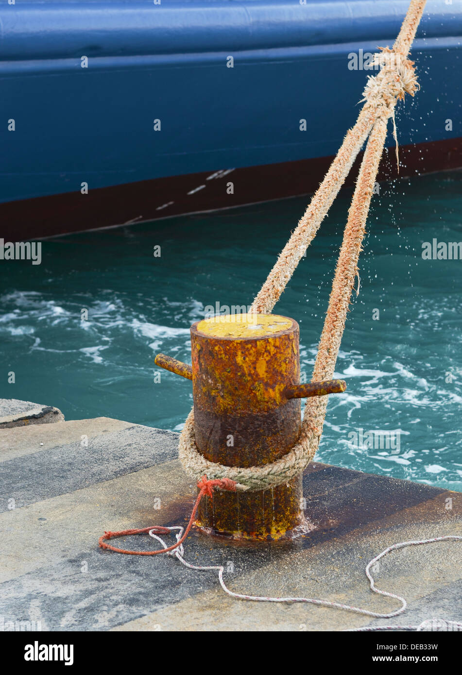 Ship fixed with rope to harbor Stock Photo - Alamy