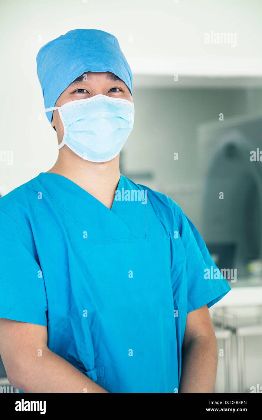 Portrait of young surgeon wearing surgical mask in the operating room ...