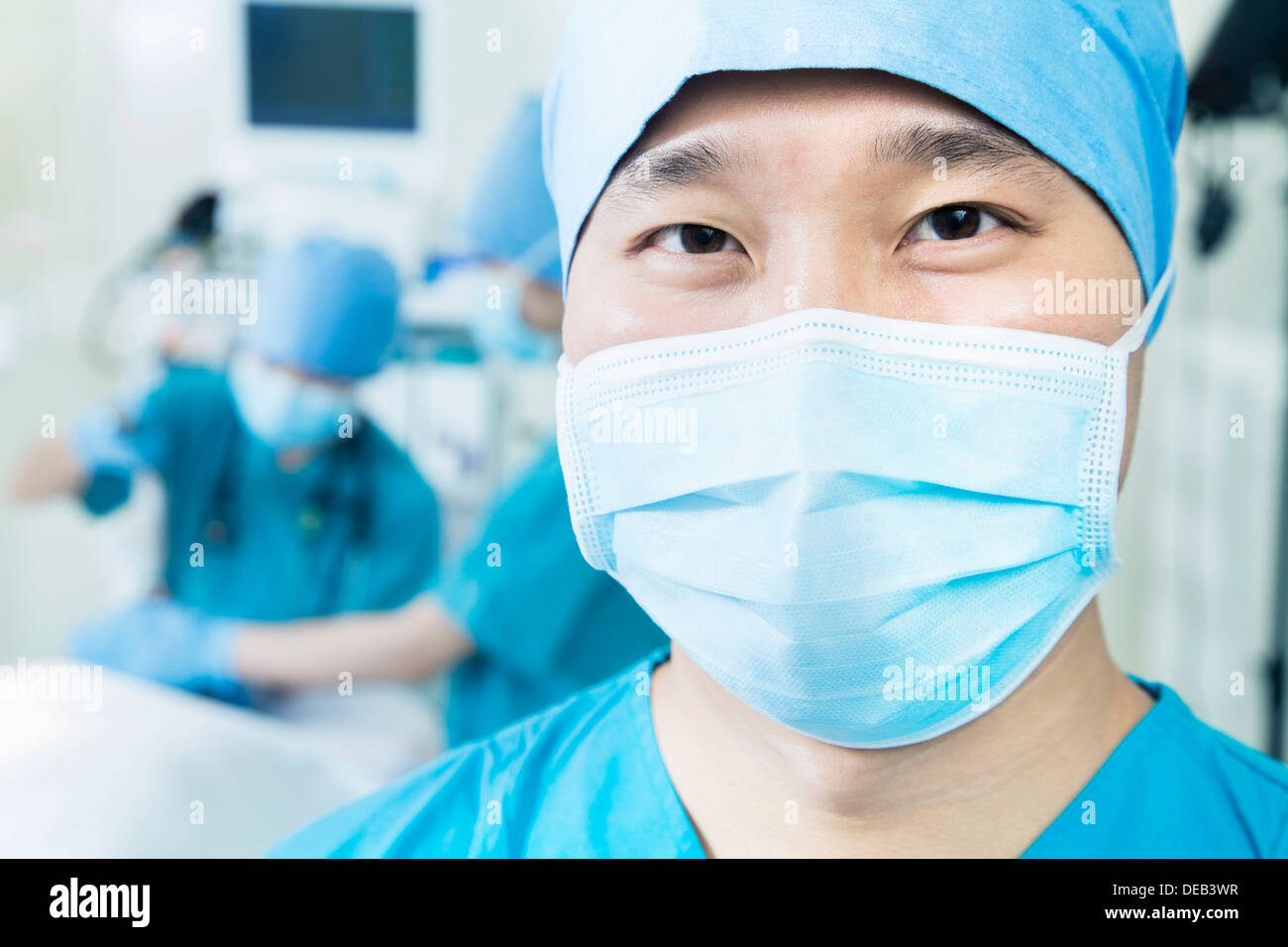 Portrait of surgeon wearing surgical mask in the operating room, close ...