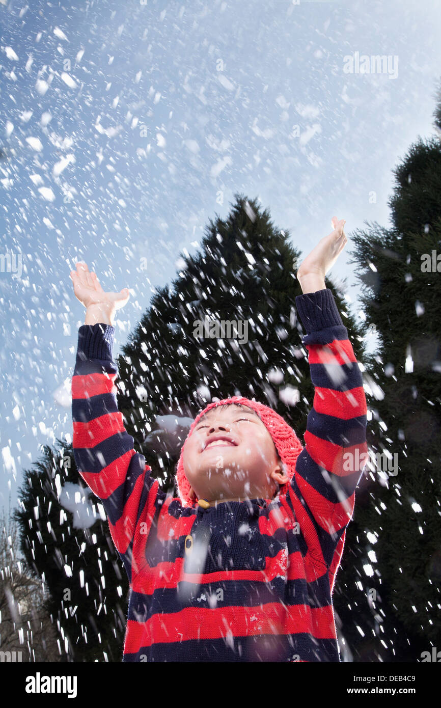 Boy with arms raised feeling the snow Stock Photo - Alamy