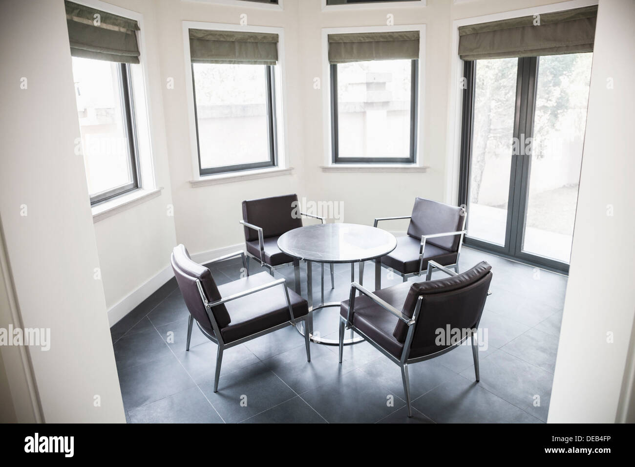 Small, modern, lounge with table and chairs Stock Photo - Alamy