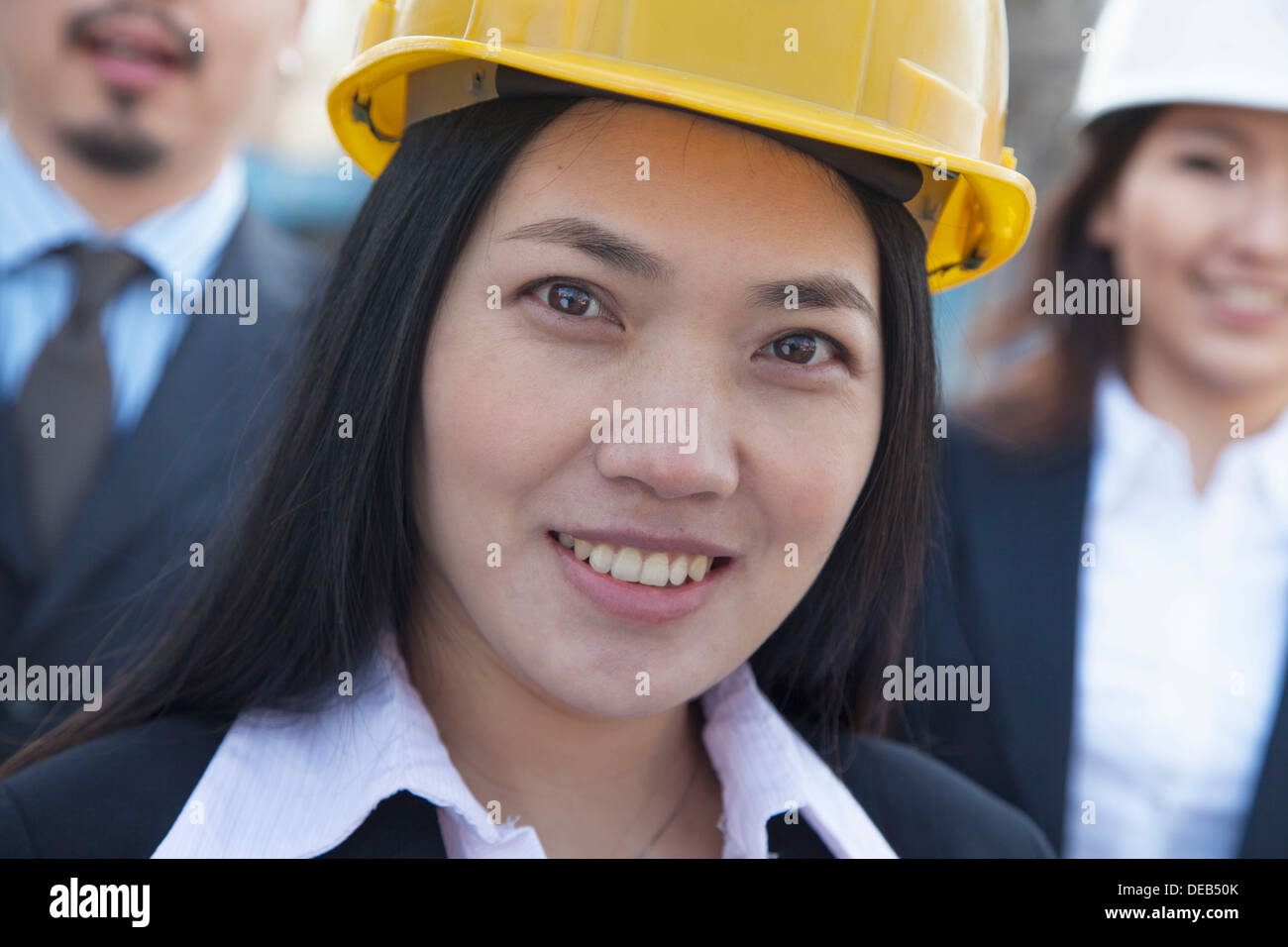 Portrait of three architects wearing hardhats, Beijing Stock Photo - Alamy
