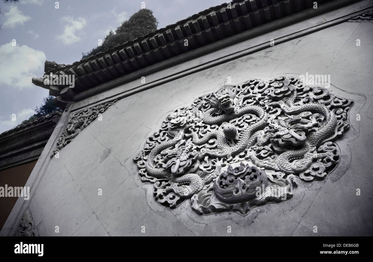 Ornate low relief sculpture of dragon on wall Stock Photo - Alamy