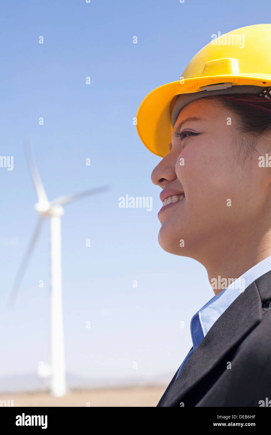 Portrait of young smiling female engineer checking wind turbines on ...