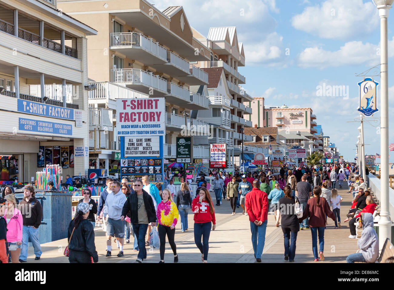 An ocean boardwalk with people, places to eat food and games of chance ...