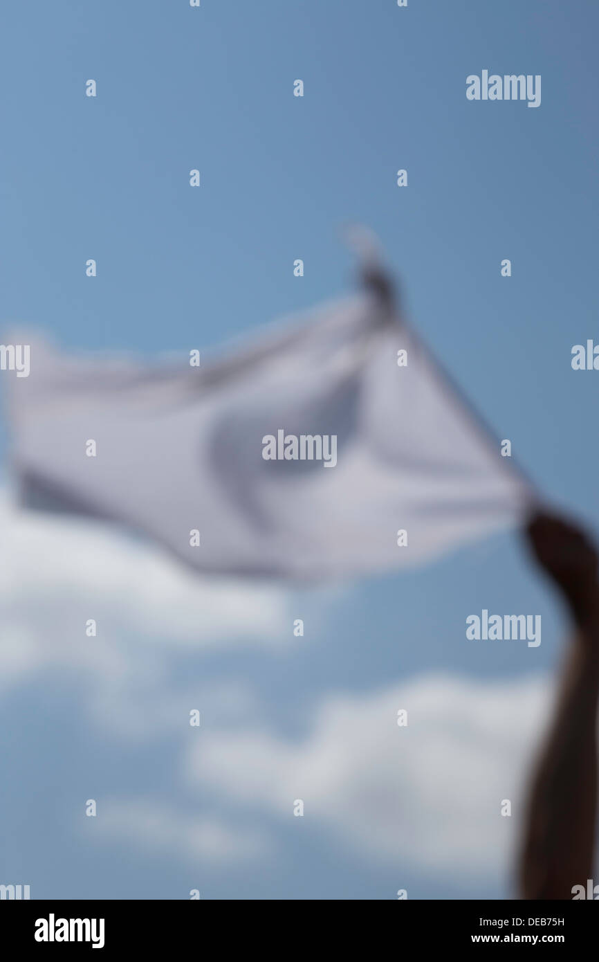 White Flag Waving Surrender Against Blue Sky Stock Photo - Alamy