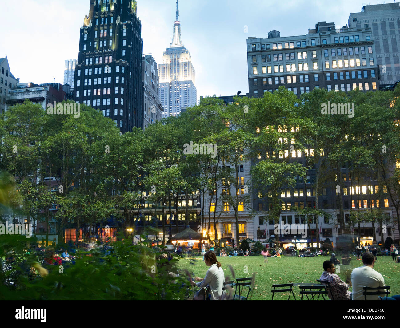 The Empire State Building Looms behind Bryant Park at Dusk, NYC Stock ...