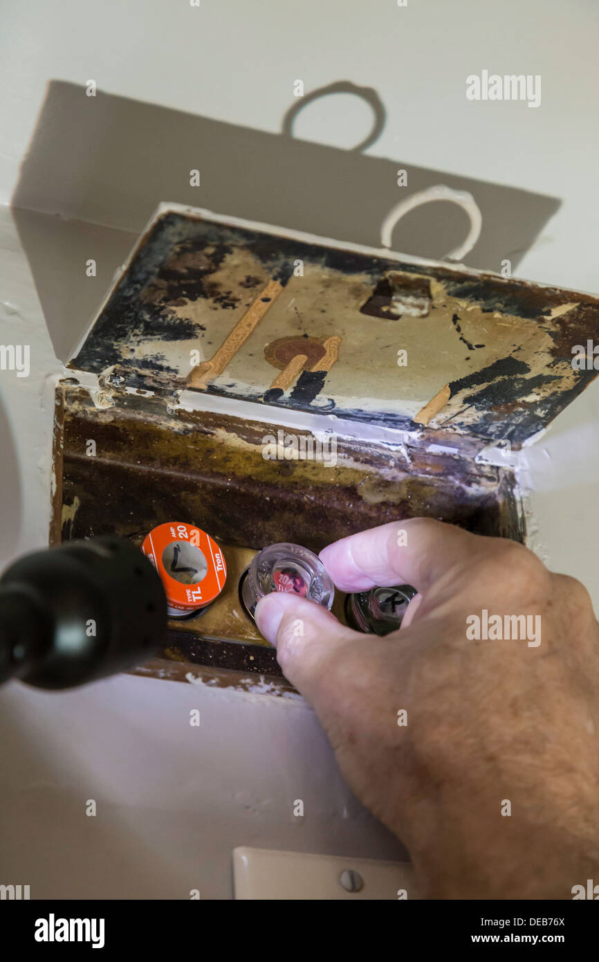 Man Changing Vintage Glass Fuse Stock Photo - Alamy