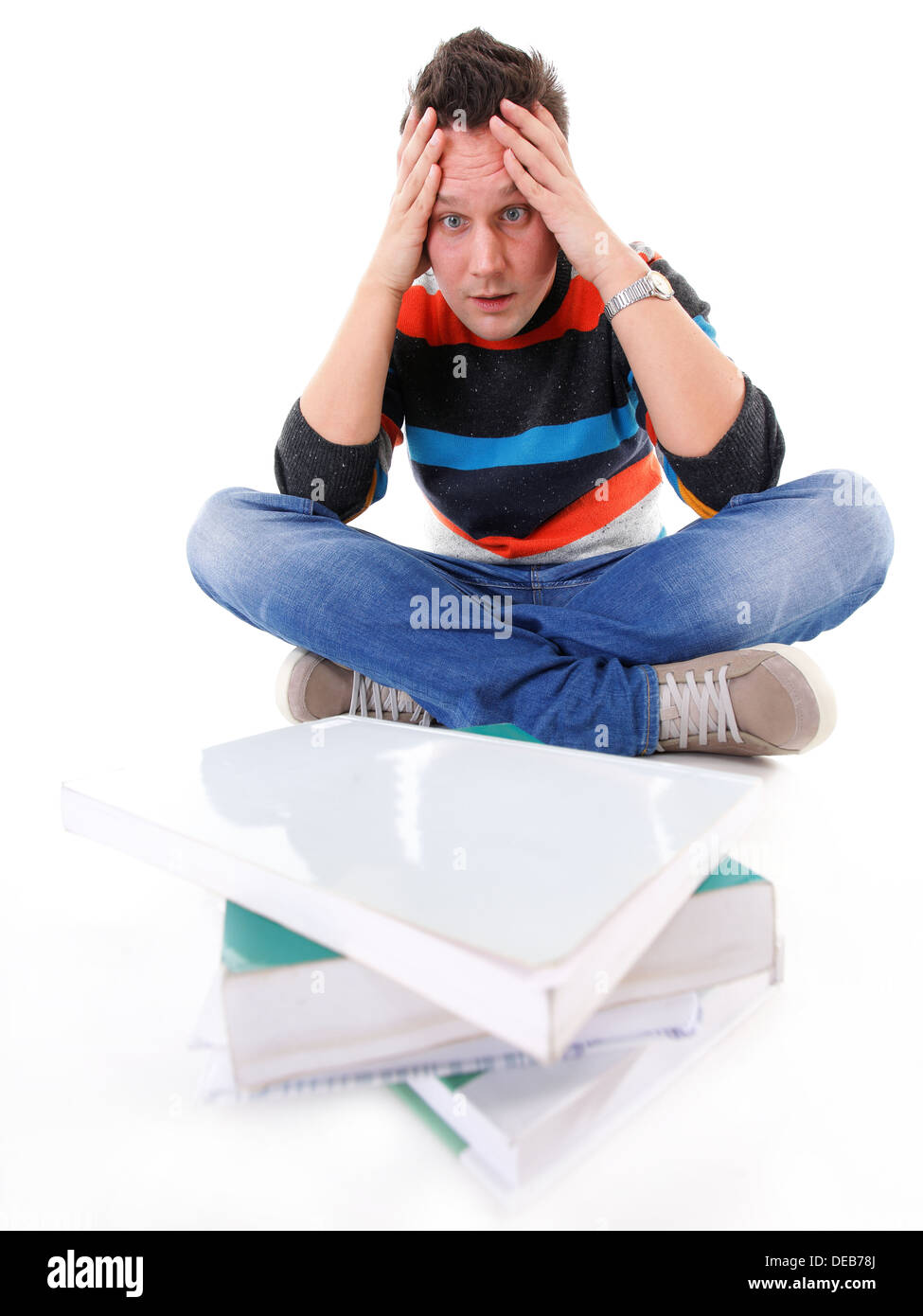 Exhausted and tired student with pile of books on white background ...