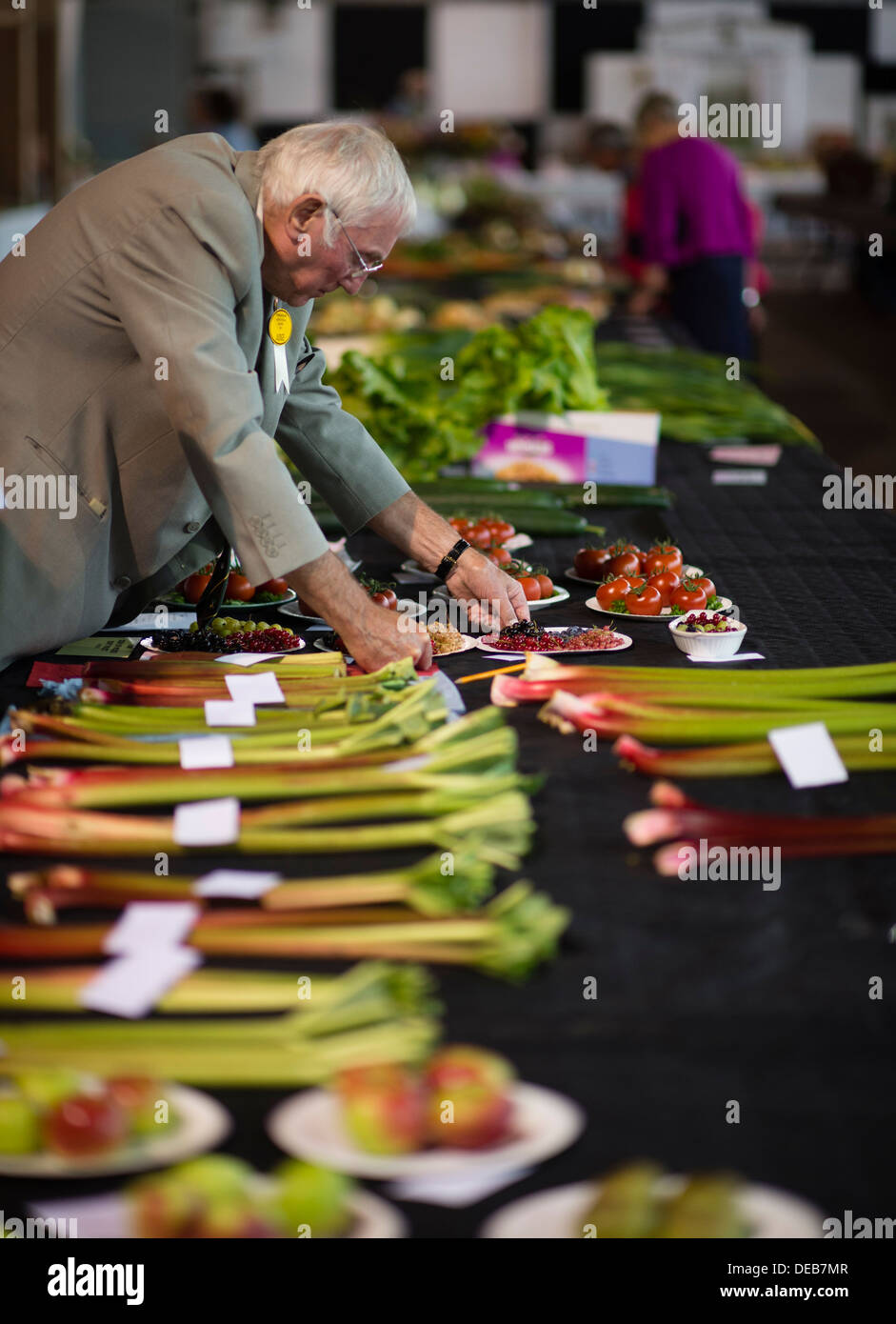 A man judging vegetables in the produce competition at the ...