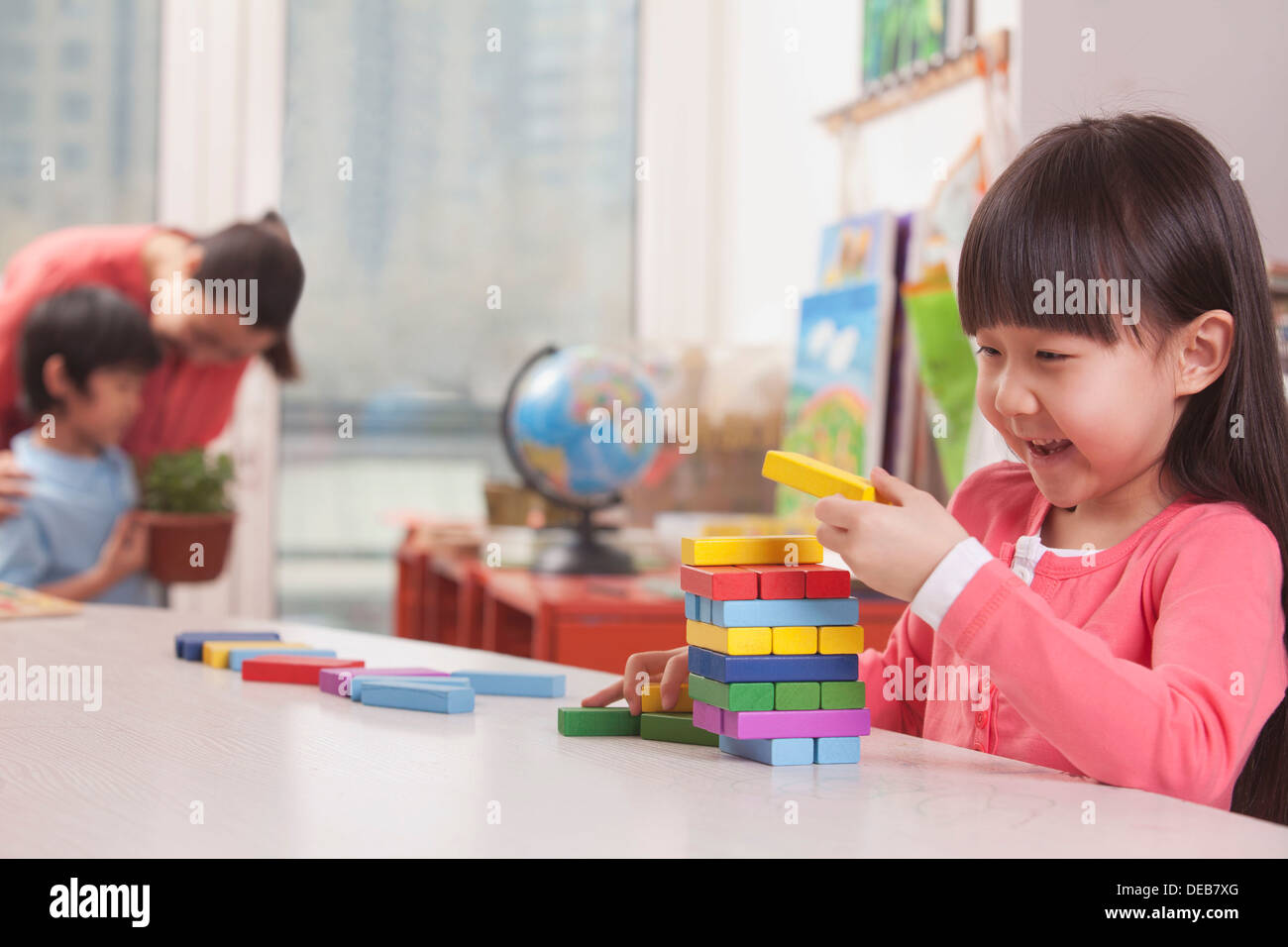 Little Girl Playing with Blocks Stock Photo - Alamy