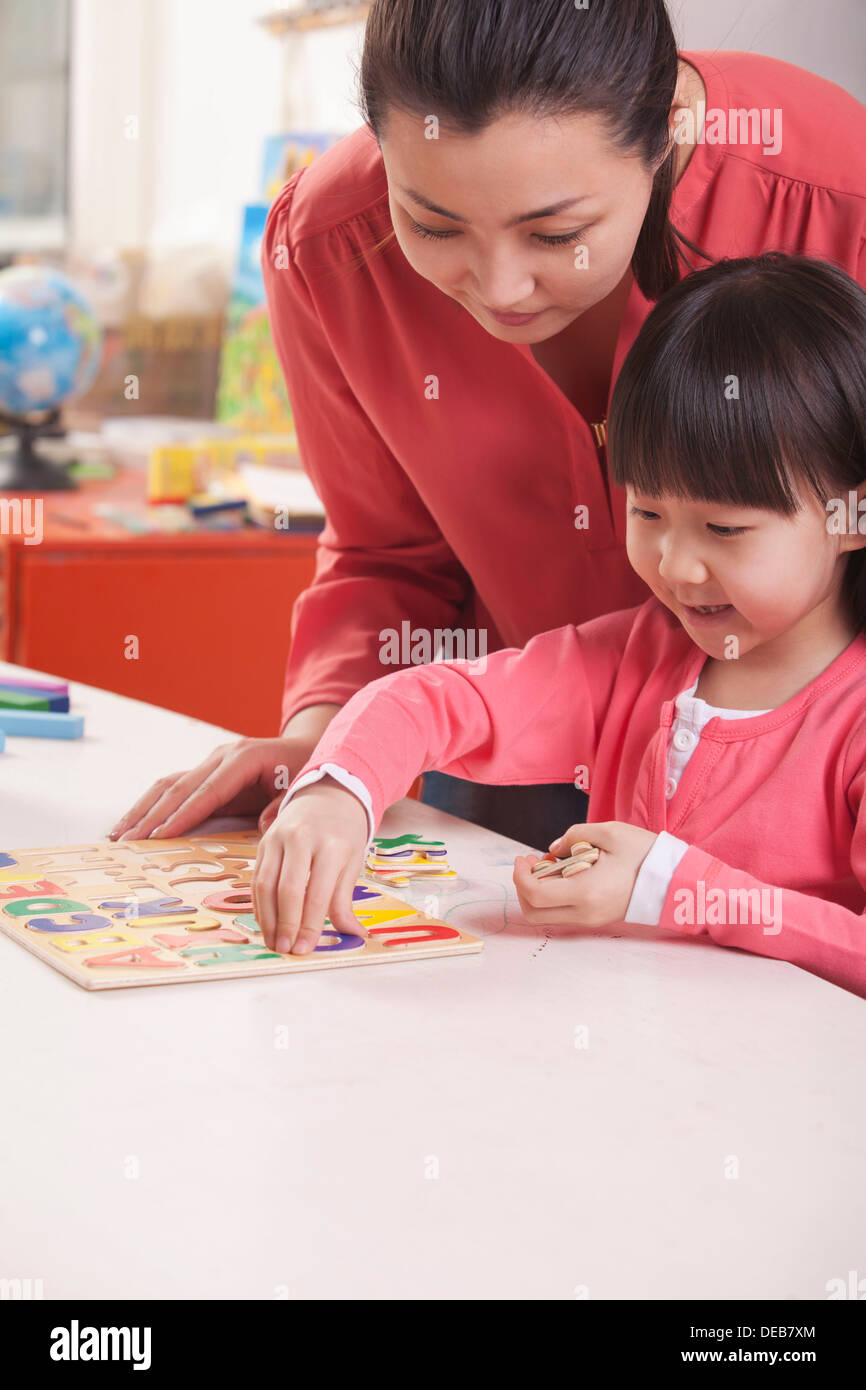 Teaching Helping Young Girl with Cut-Out Alphabet Letters Stock Photo ...