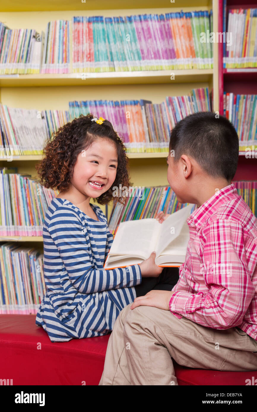Boy and Girl Reading Together Stock Photo - Alamy