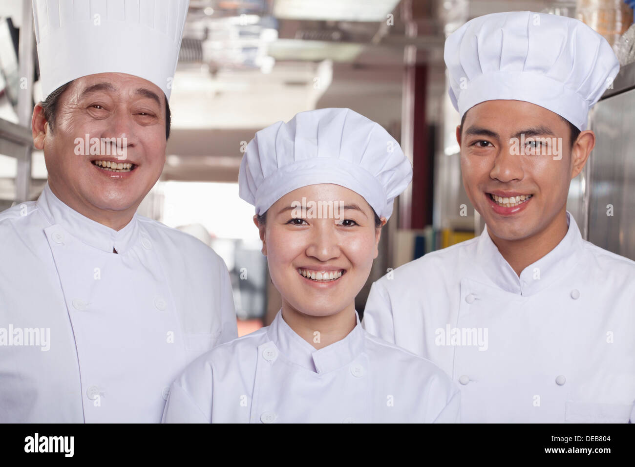 Three Chefs in an Industrial Kitchen Stock Photo - Alamy