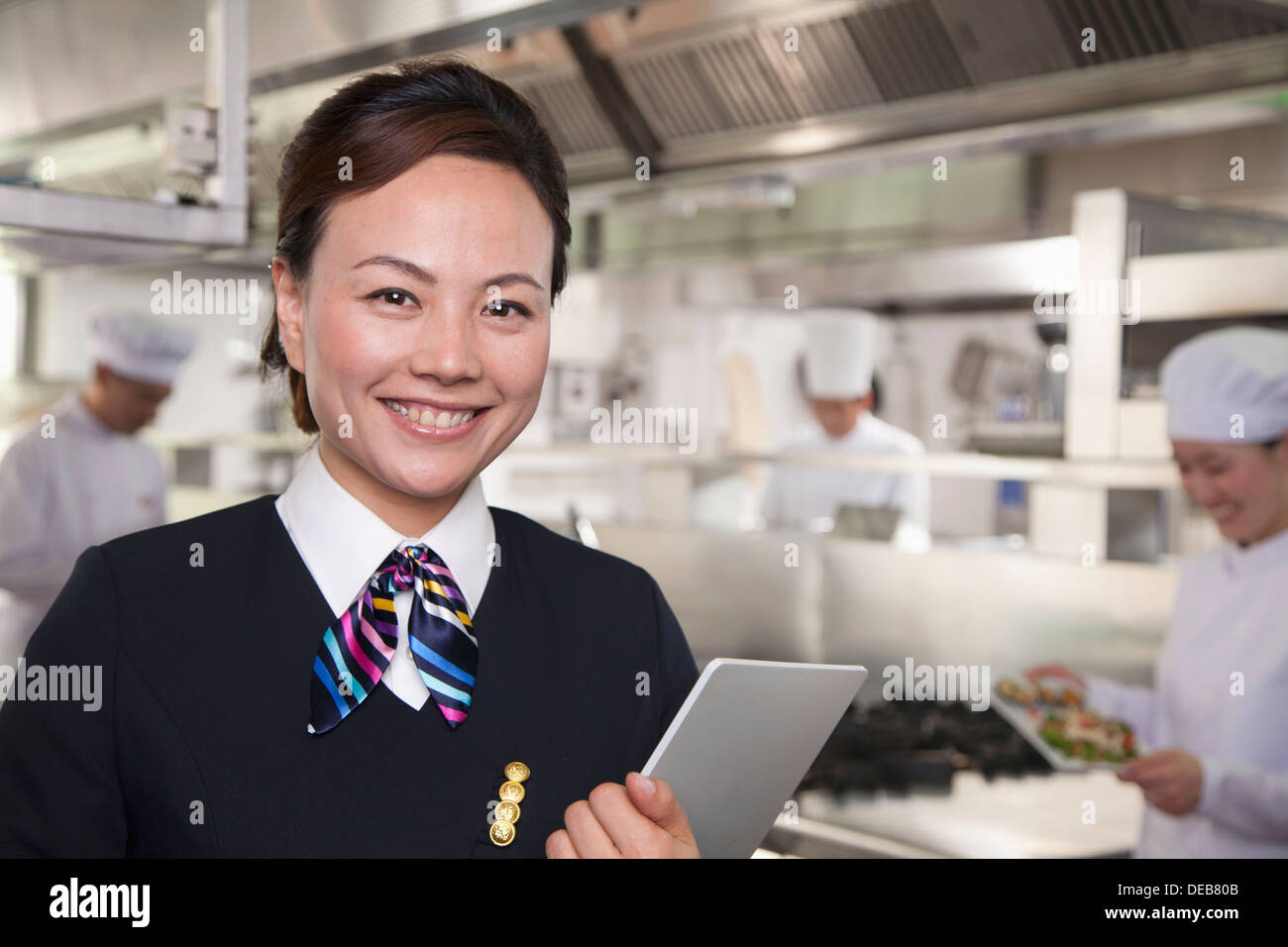 Restaurant Hostess in an Industrial Kitchen Stock Photo - Alamy
