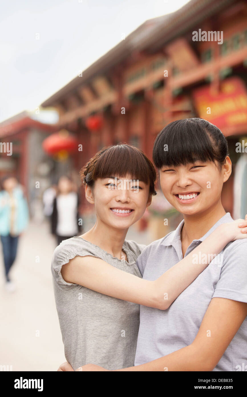 Two friends laughing and embracing Stock Photo - Alamy