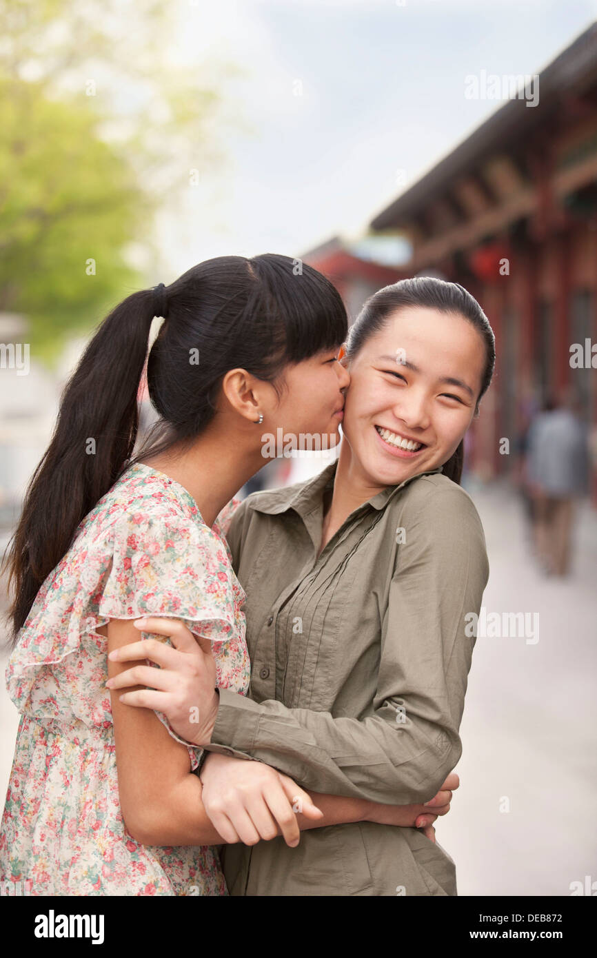 Two young women embracing Stock Photo - Alamy