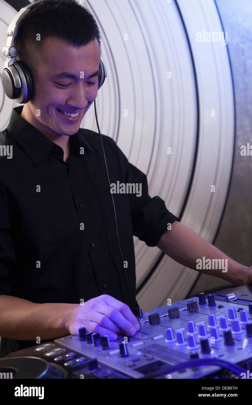 A portrait of a young male DJ playing music in a nightclub Stock Photo ...