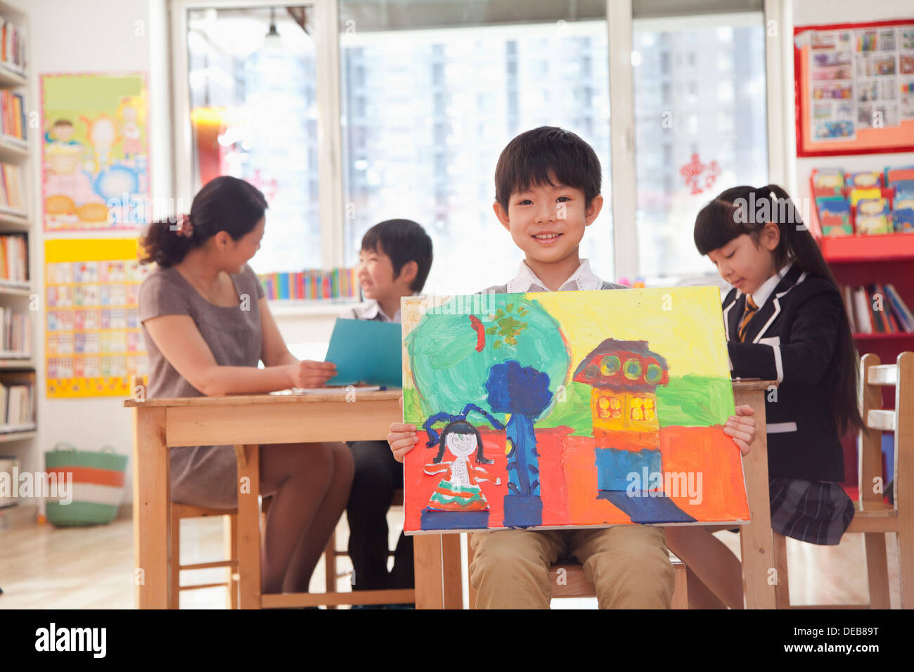 Portrait of one student holding a painting Stock Photo - Alamy