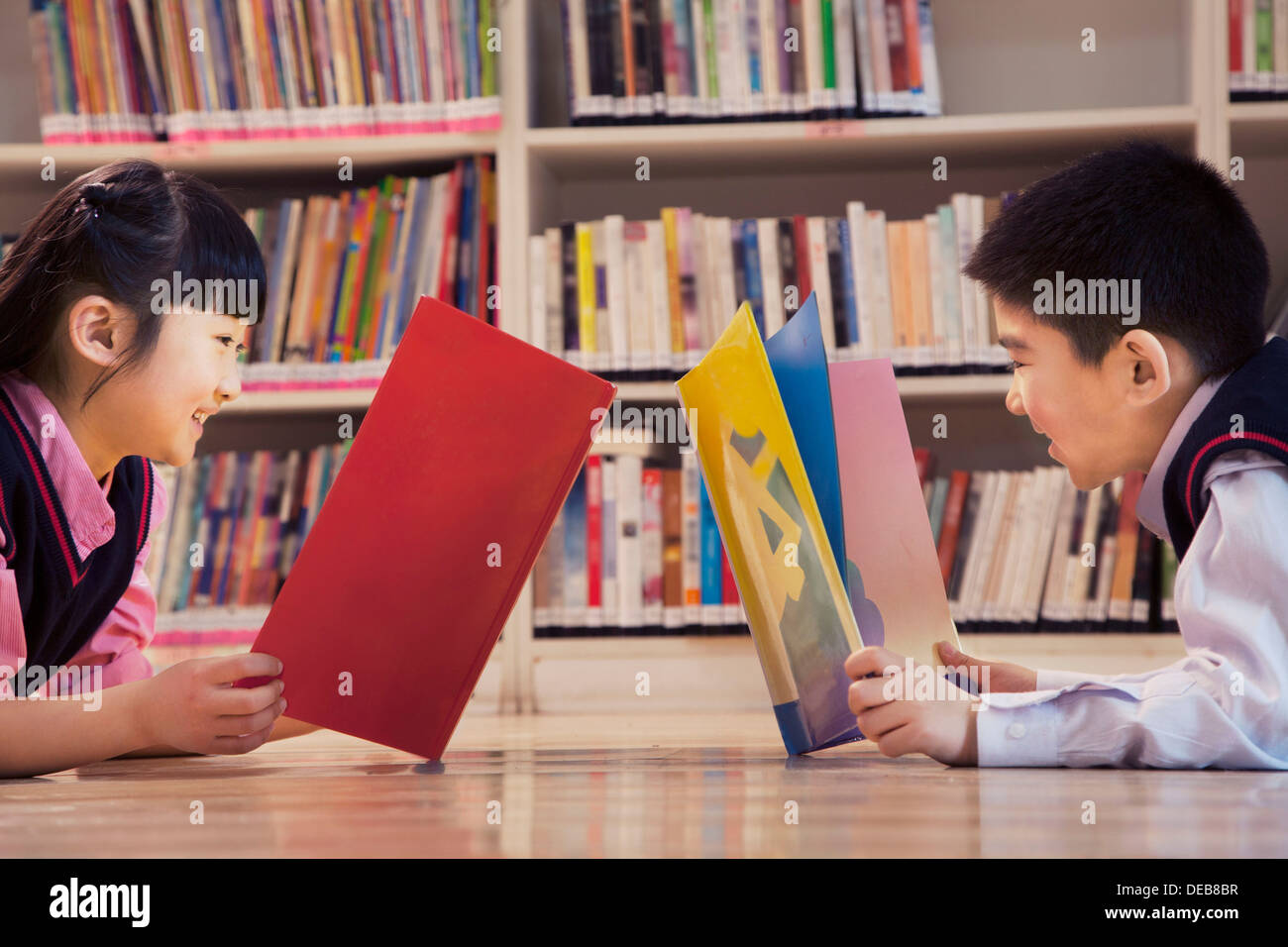 School children reading books in the library Stock Photo - Alamy