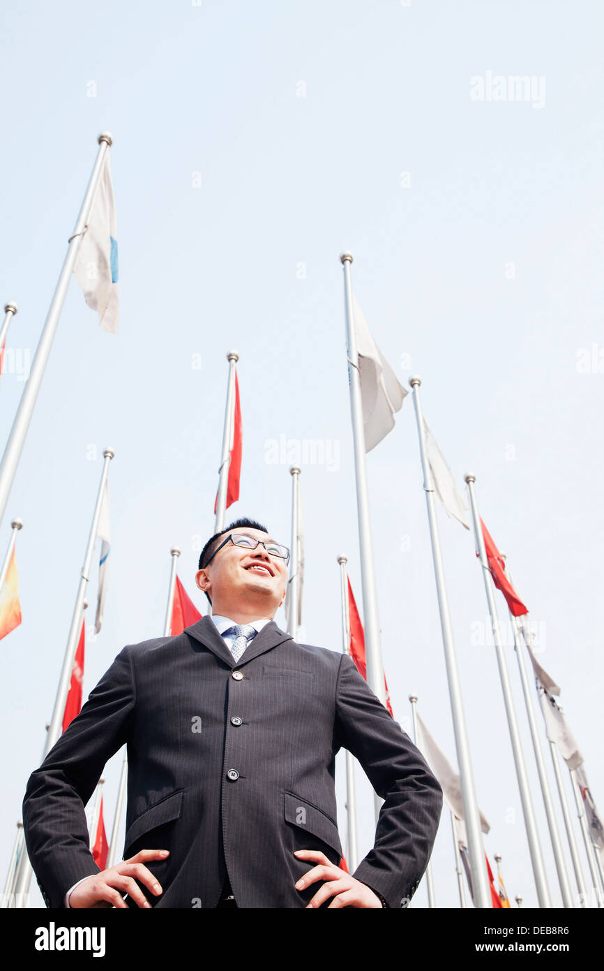 Portrait of smiling young businessman, flags in background Stock Photo ...