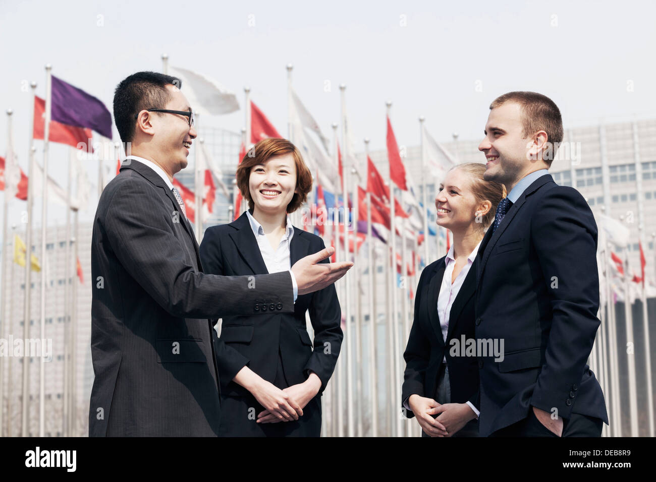 Four chinese young people talking hi-res stock photography and images ...