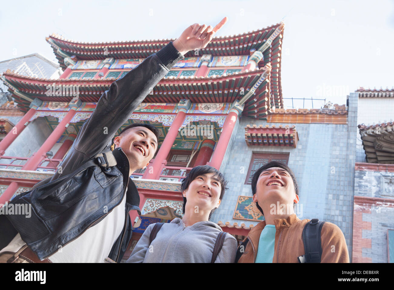 Three people sightseeing, looking and pointing Stock Photo - Alamy