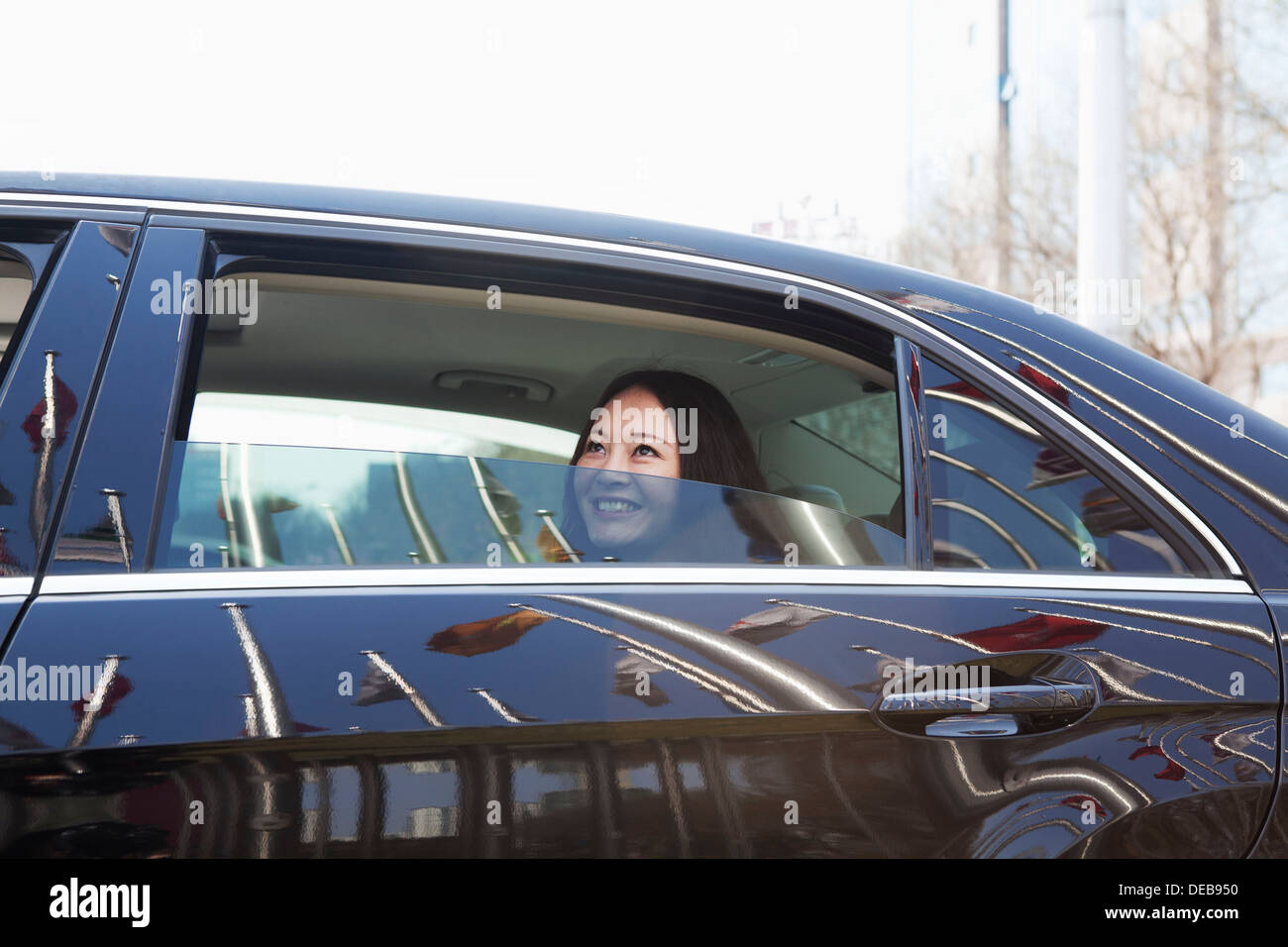 Young women in back seat of car looking out of window Stock Photo - Alamy