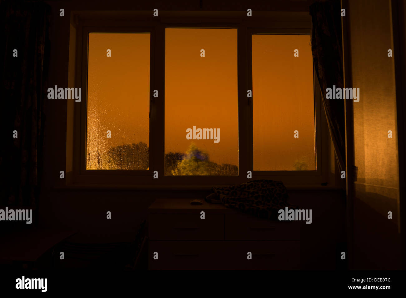 Light pollution city yellow amber sky rain window Stock Photo - Alamy