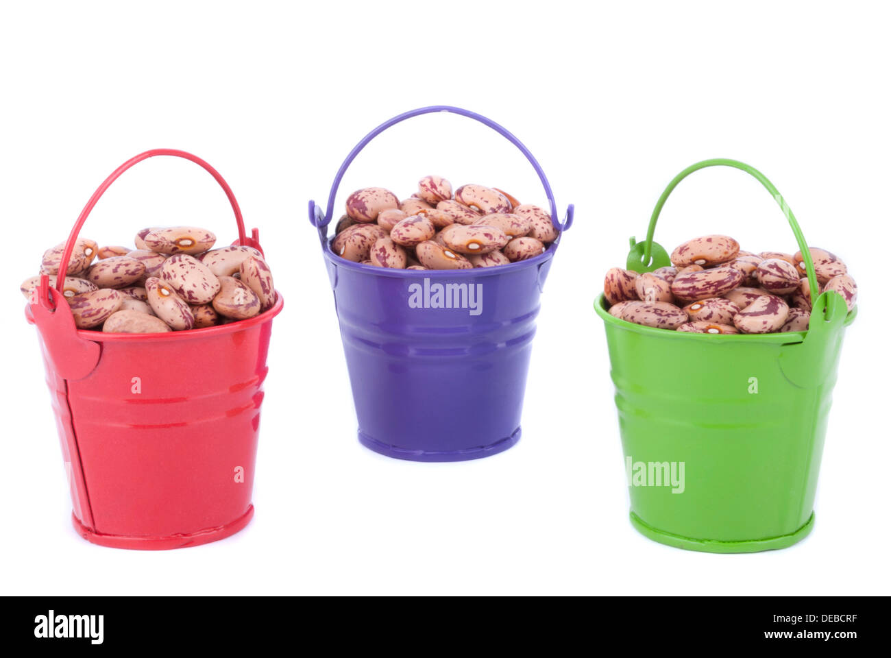 Multicolored buckets with beans on a white background Stock Photo - Alamy